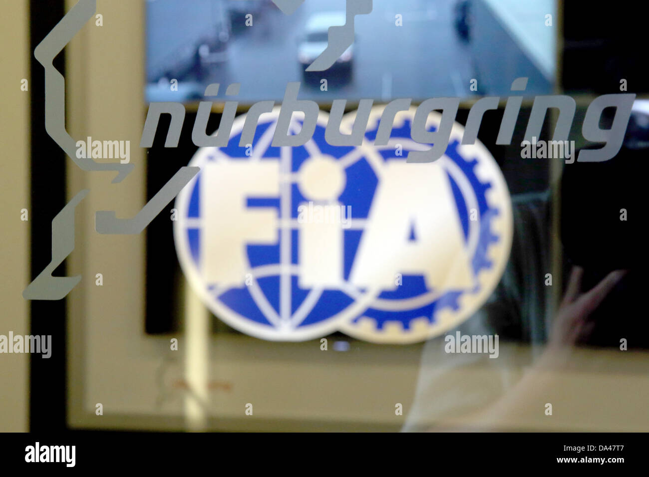 The logo of FIA (Fédération Internationale de l'Automobile) behind a glass door with the logo of ...