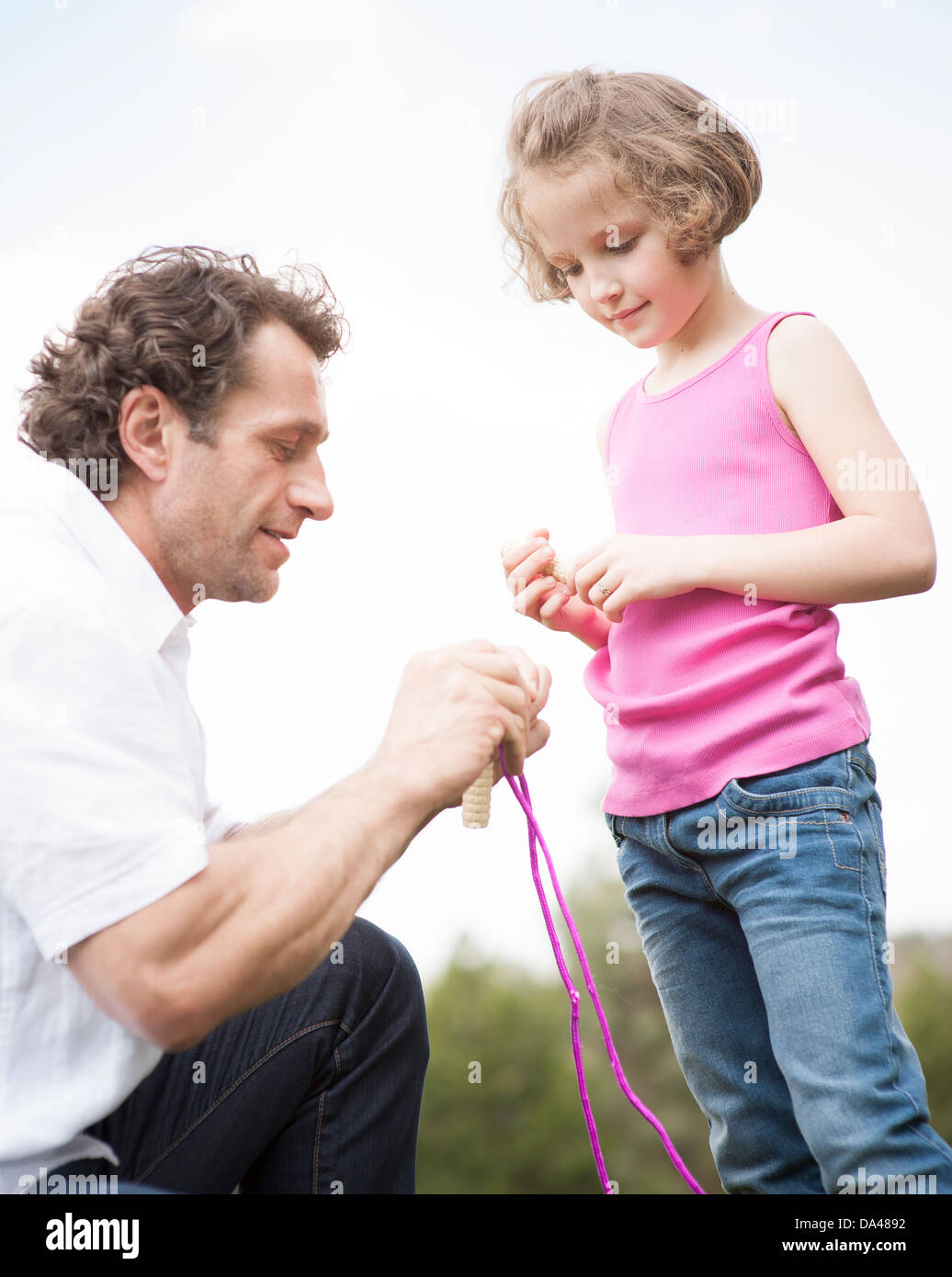 Father and daughter together with skipping rope Stock Photo - Alamy
