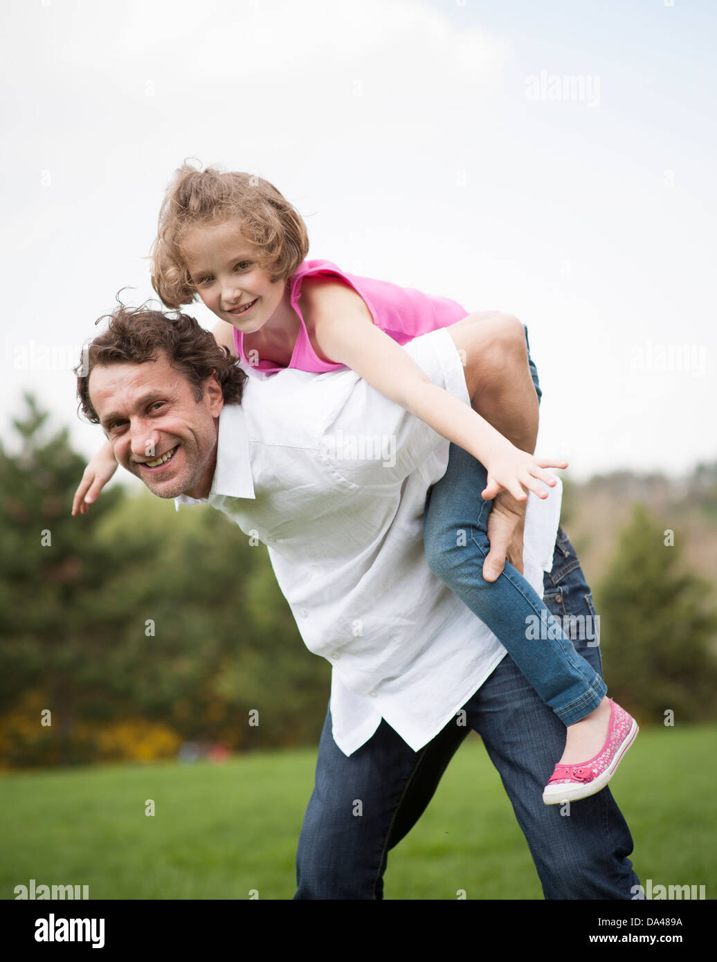 Father giving young daughter piggyback ride Stock Photo - Alamy