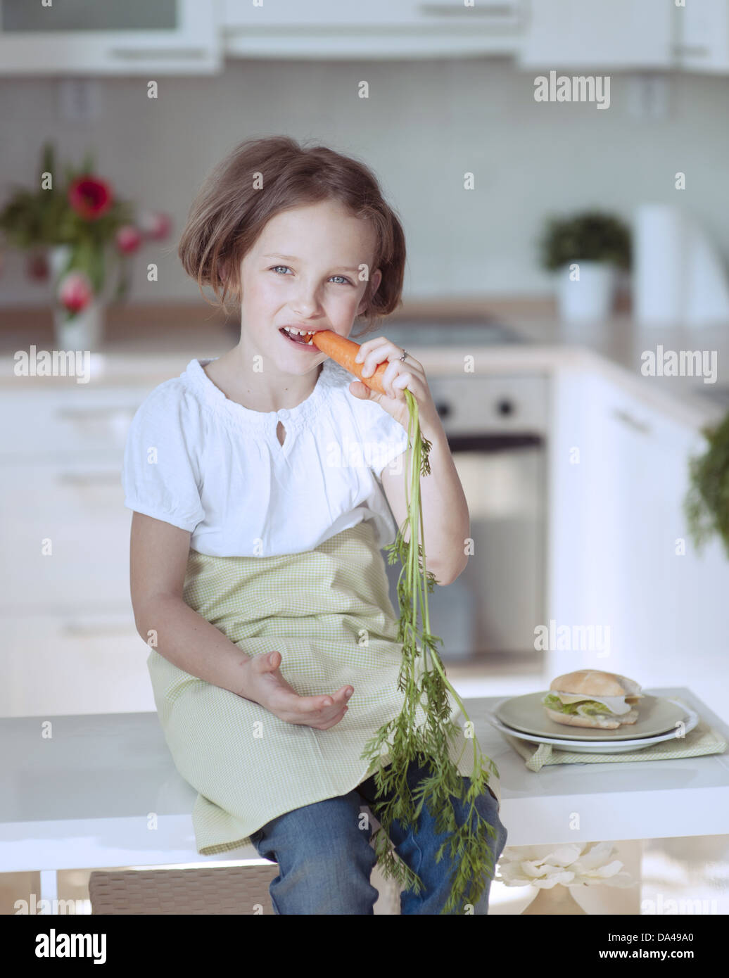 Young girl eating carrot Stock Photo - Alamy