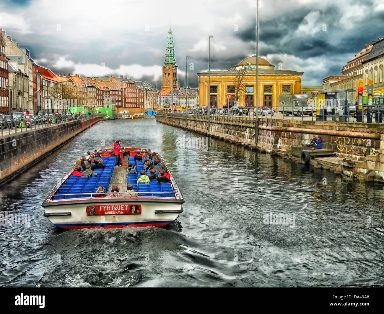 This scene captures tourists enjoying a canal boat ride in Copenhagen ...
