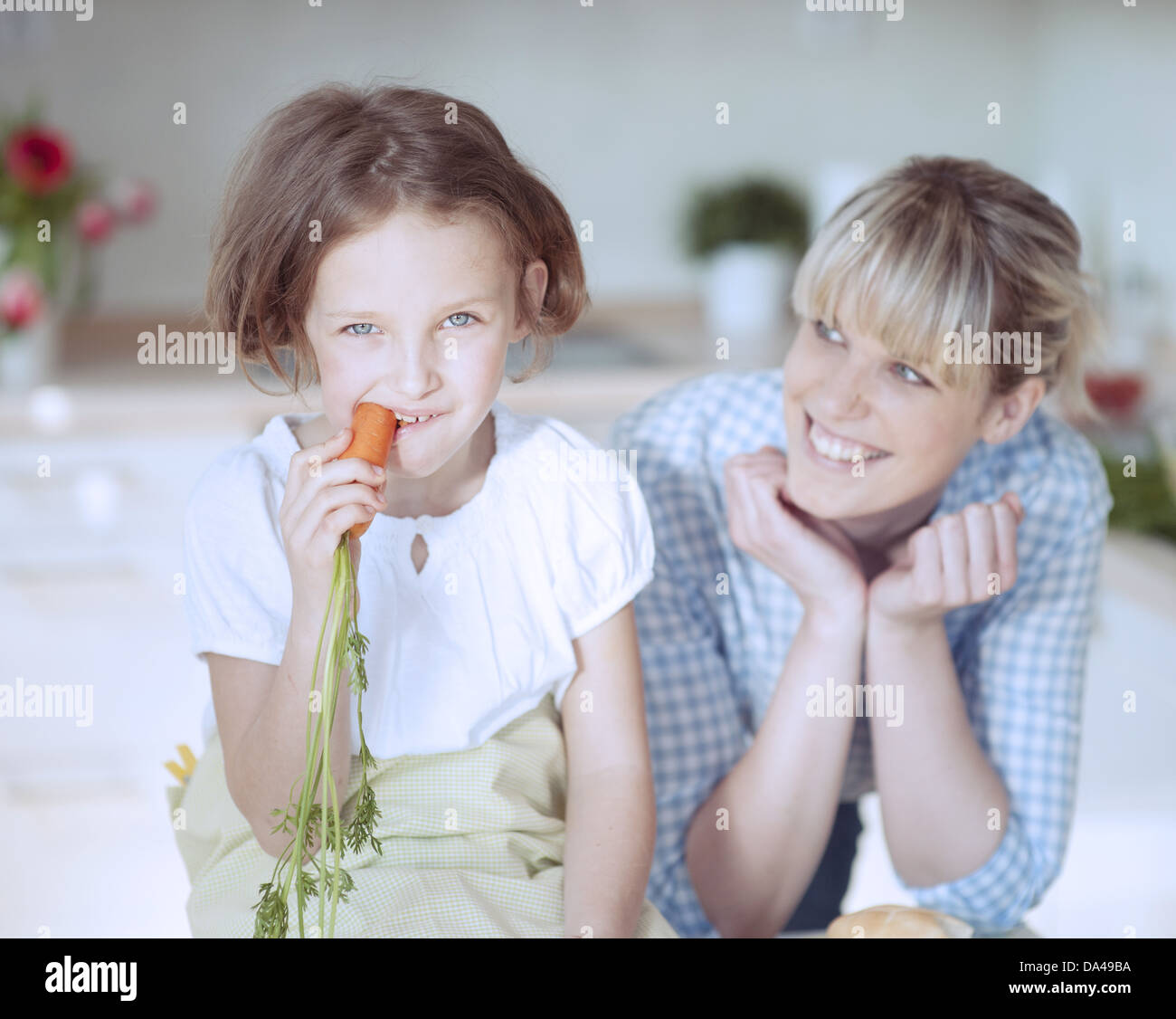 Young girl eating carrot Stock Photo - Alamy