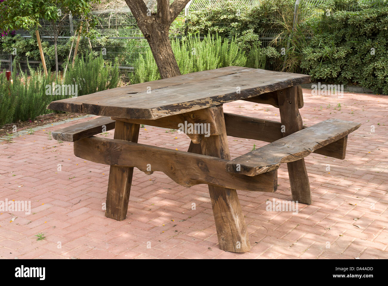 Wood picnic table and benches in the park Stock Photo - Alamy
