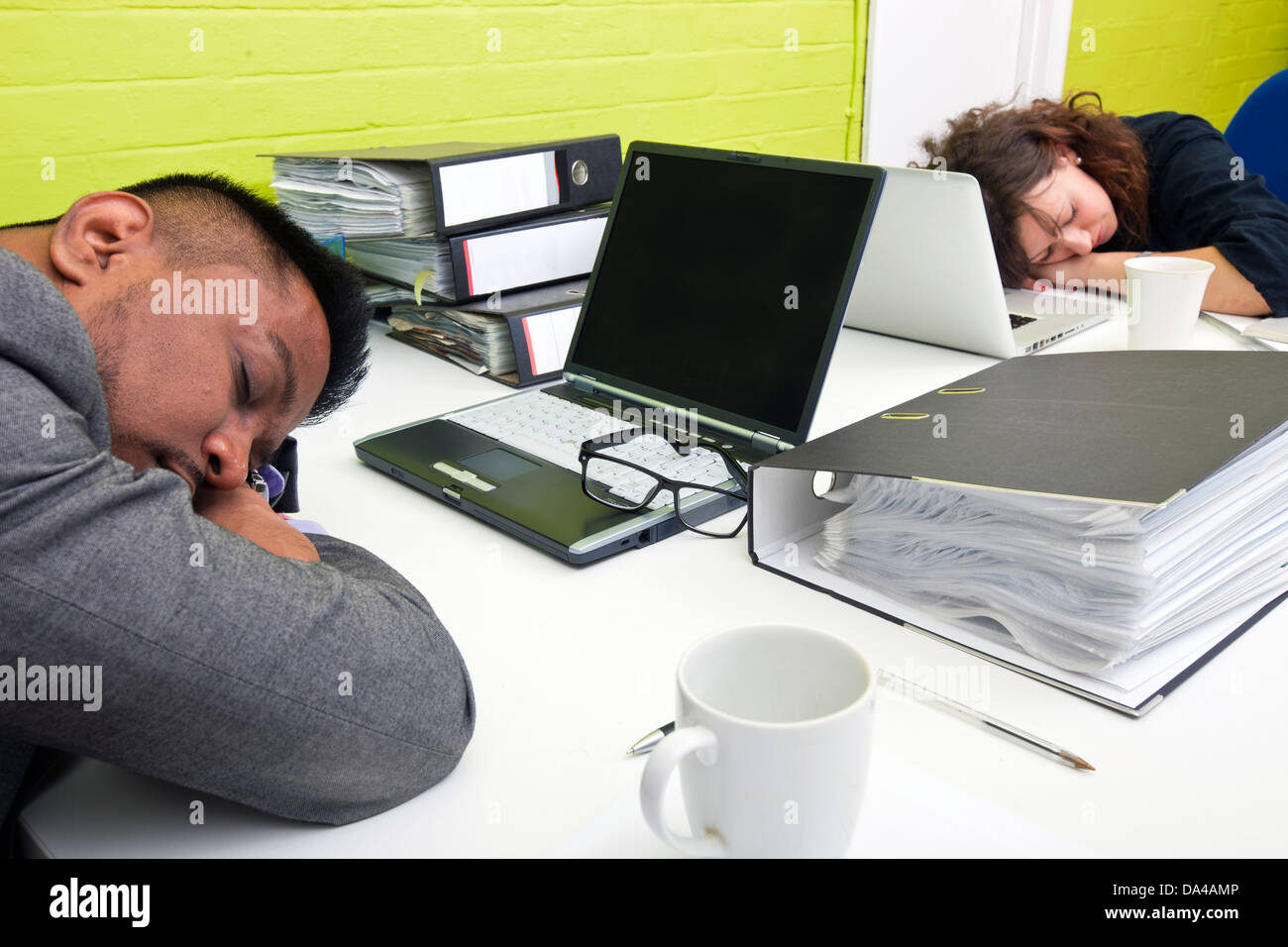 Colleagues asleep at their respective desk Stock Photo - Alamy