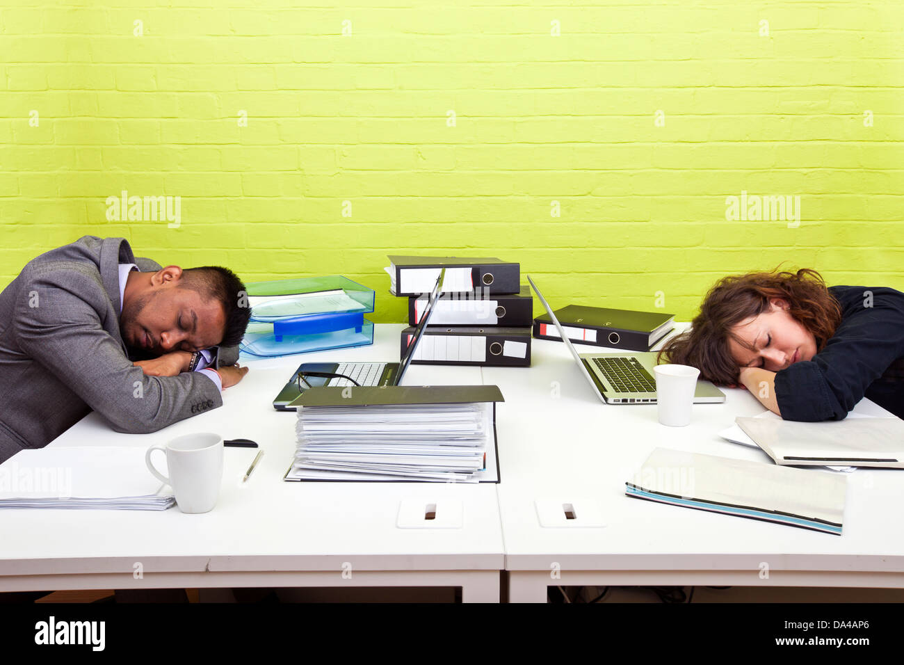 Colleagues asleep at their respective desk Stock Photo - Alamy