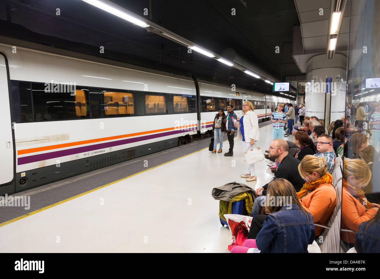 Passengers waiting to board train hi-res stock photography and images ...