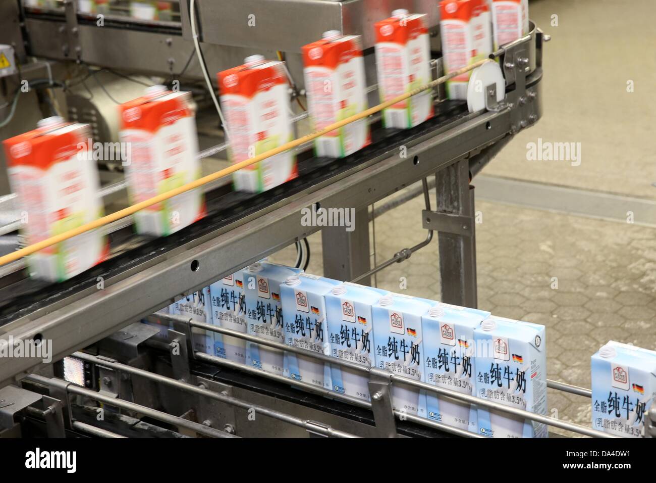 Cartons of milk destined for the market in China run through the ...