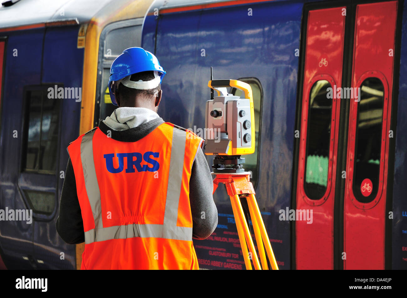 A worker standing next to survey equipment at Bristol Temple Meads ...