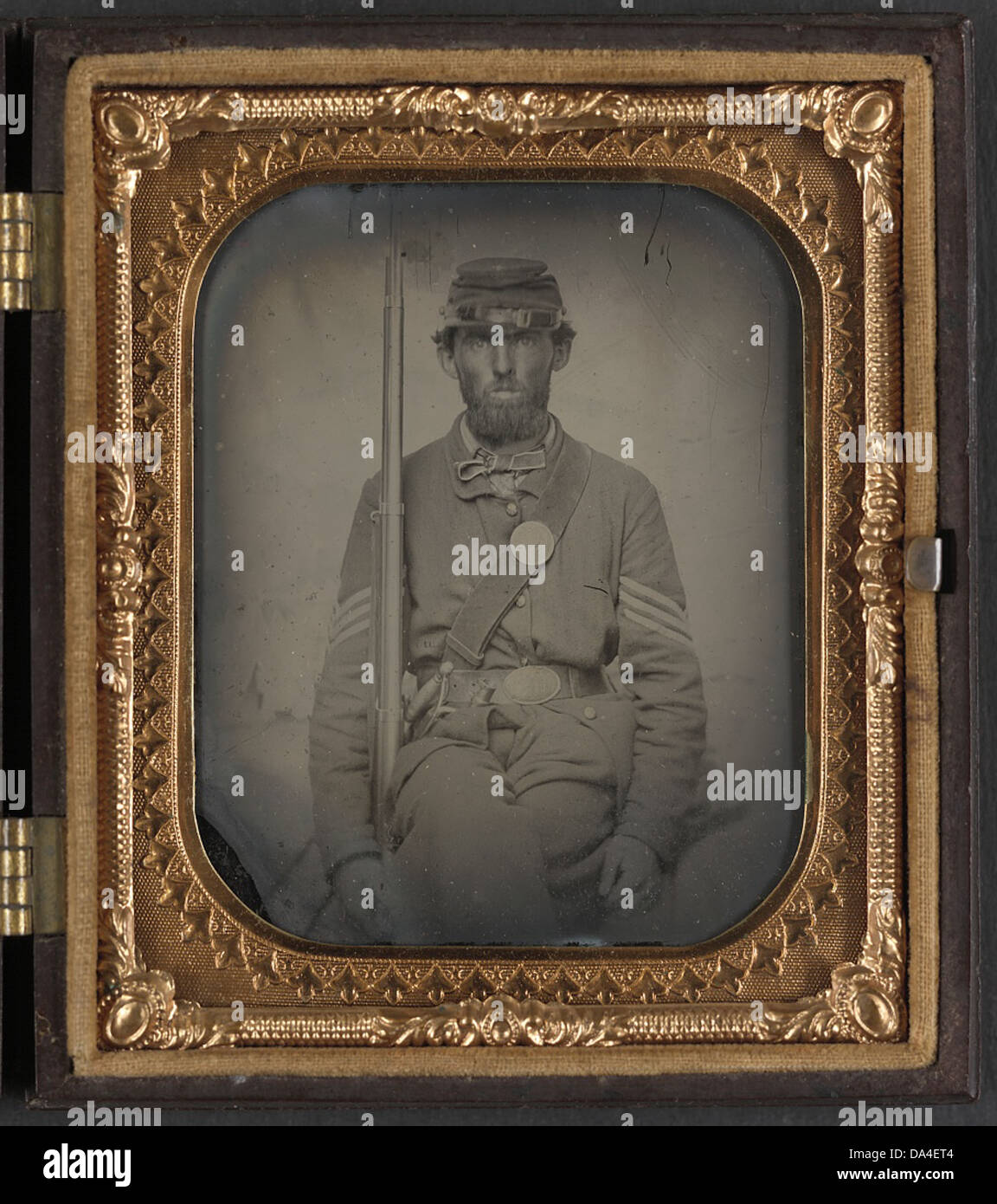 This photograph shows an unidentified Union soldier dressed in a ...
