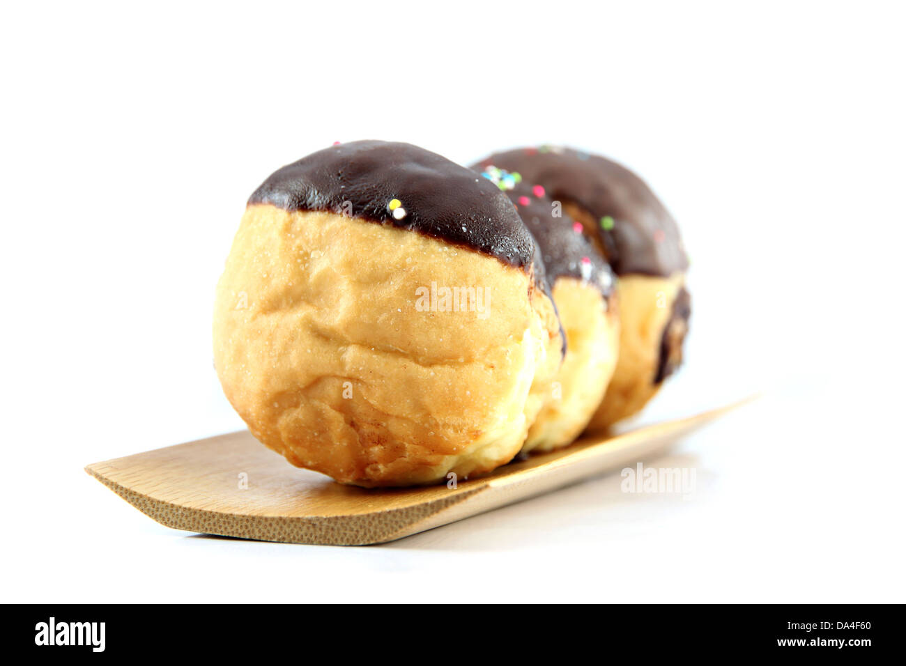 Chocolate donuts in the Bamboo dish on the white background Stock Photo ...