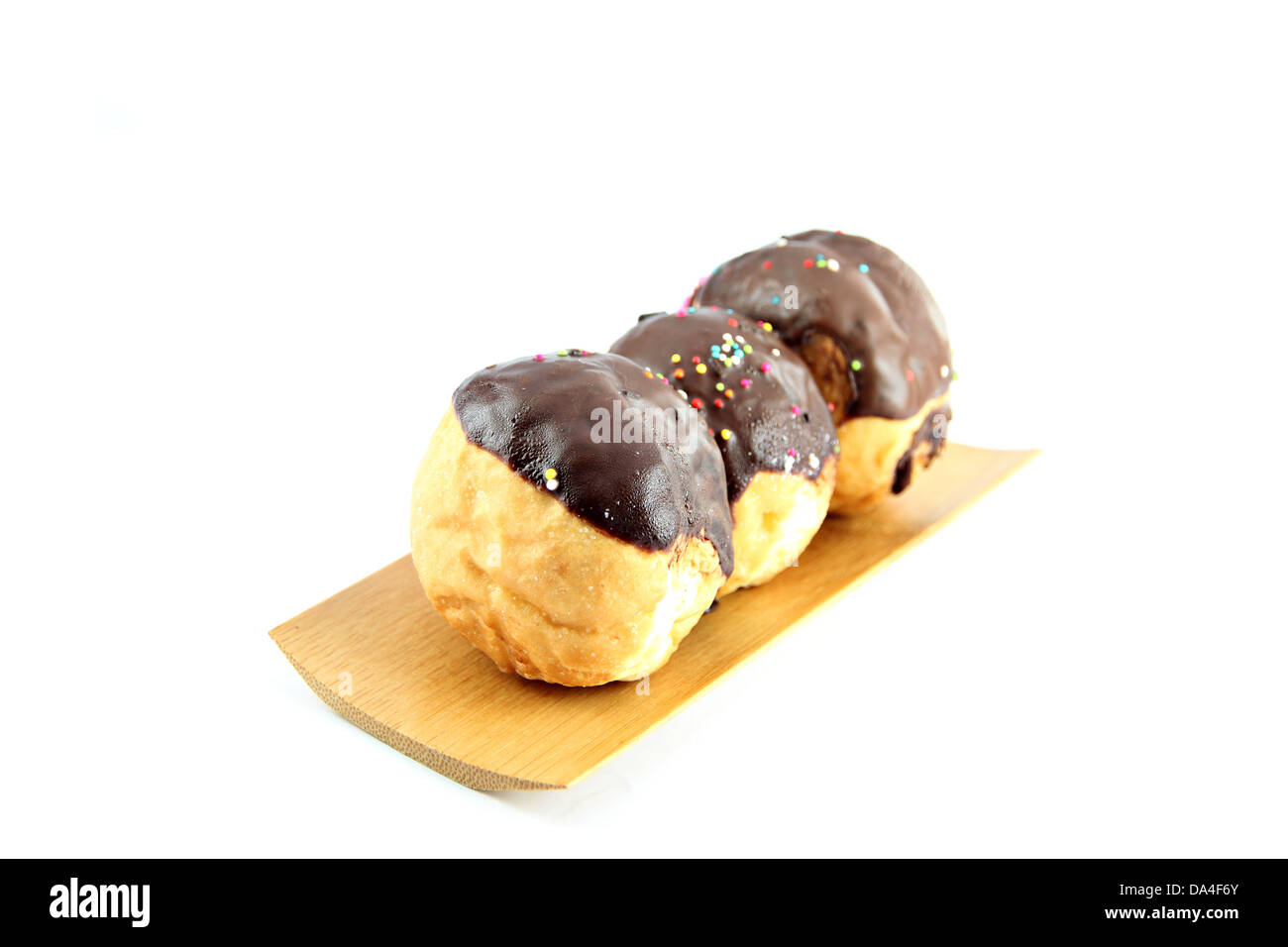 Chocolate donuts in the Bamboo dish on the white background Stock Photo ...