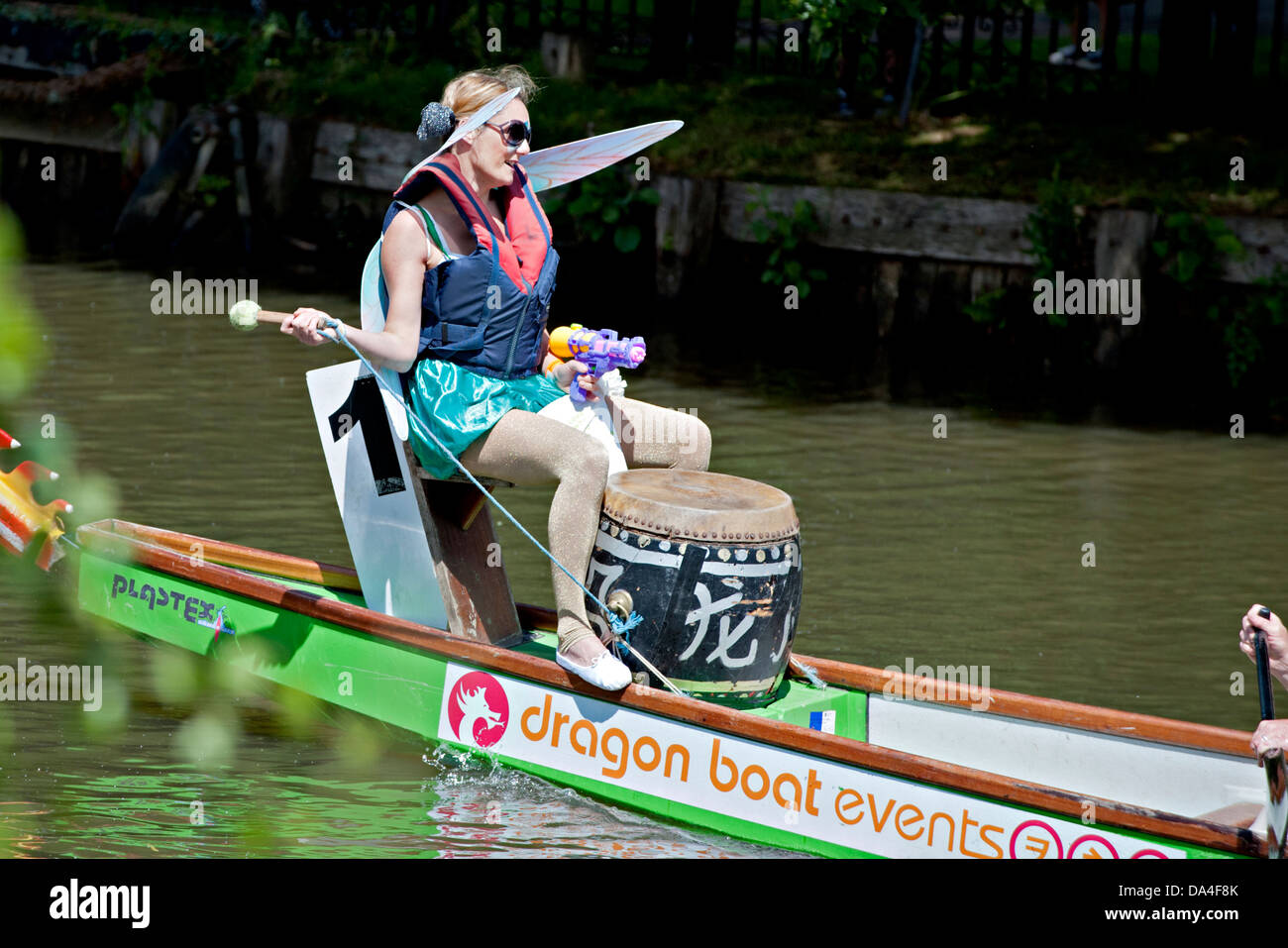 A female drummer on a Dragon Boat. The race was started by Dame Kelly ...
