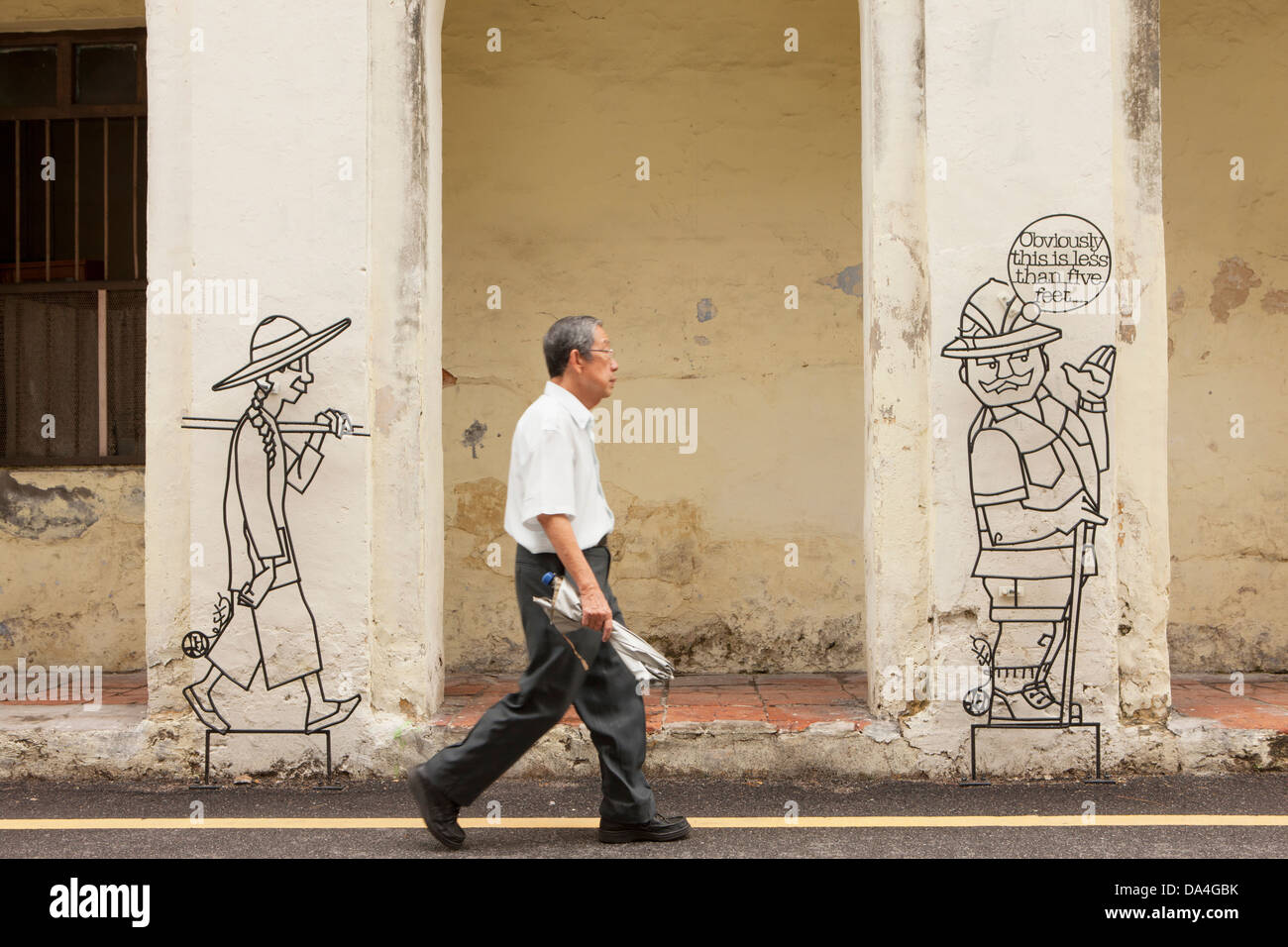 Man walking past street art, Georgetown, Penang, Malaysia Stock Photo ...