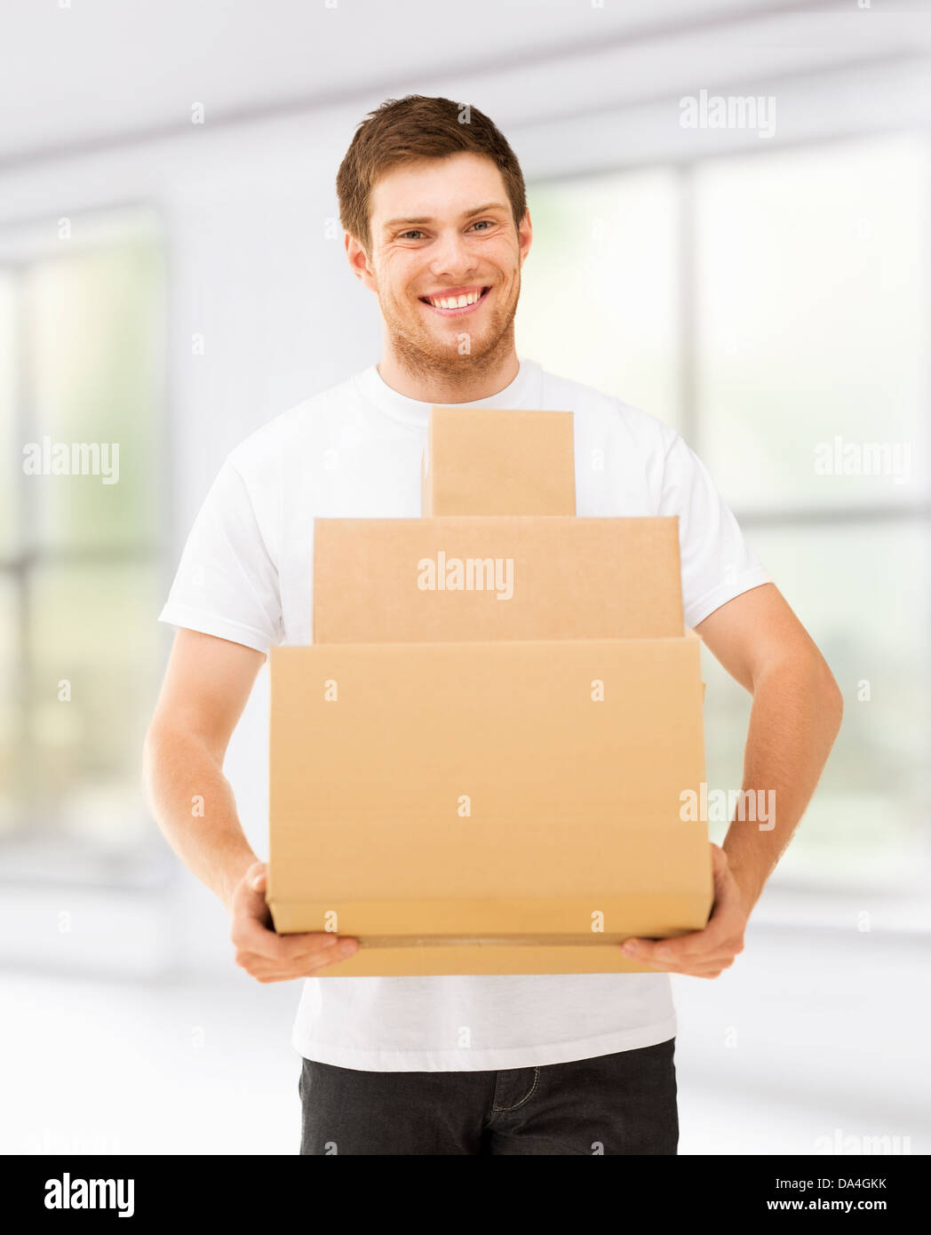 smiling man carrying carton boxes at home Stock Photo - Alamy