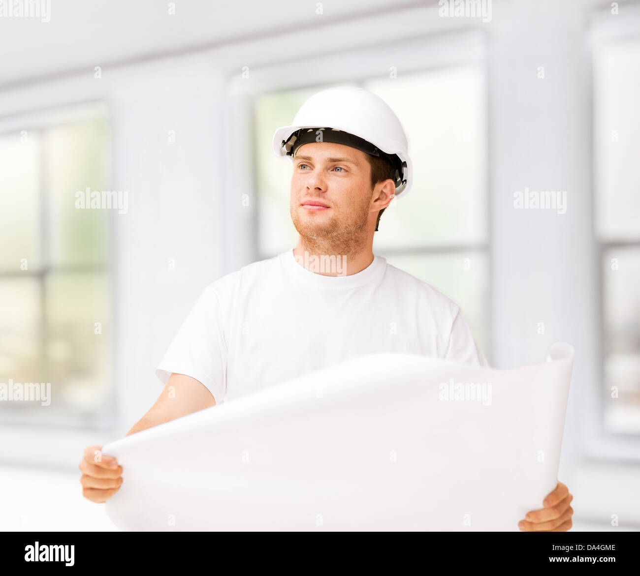 male architect looking at blueprint at home Stock Photo - Alamy