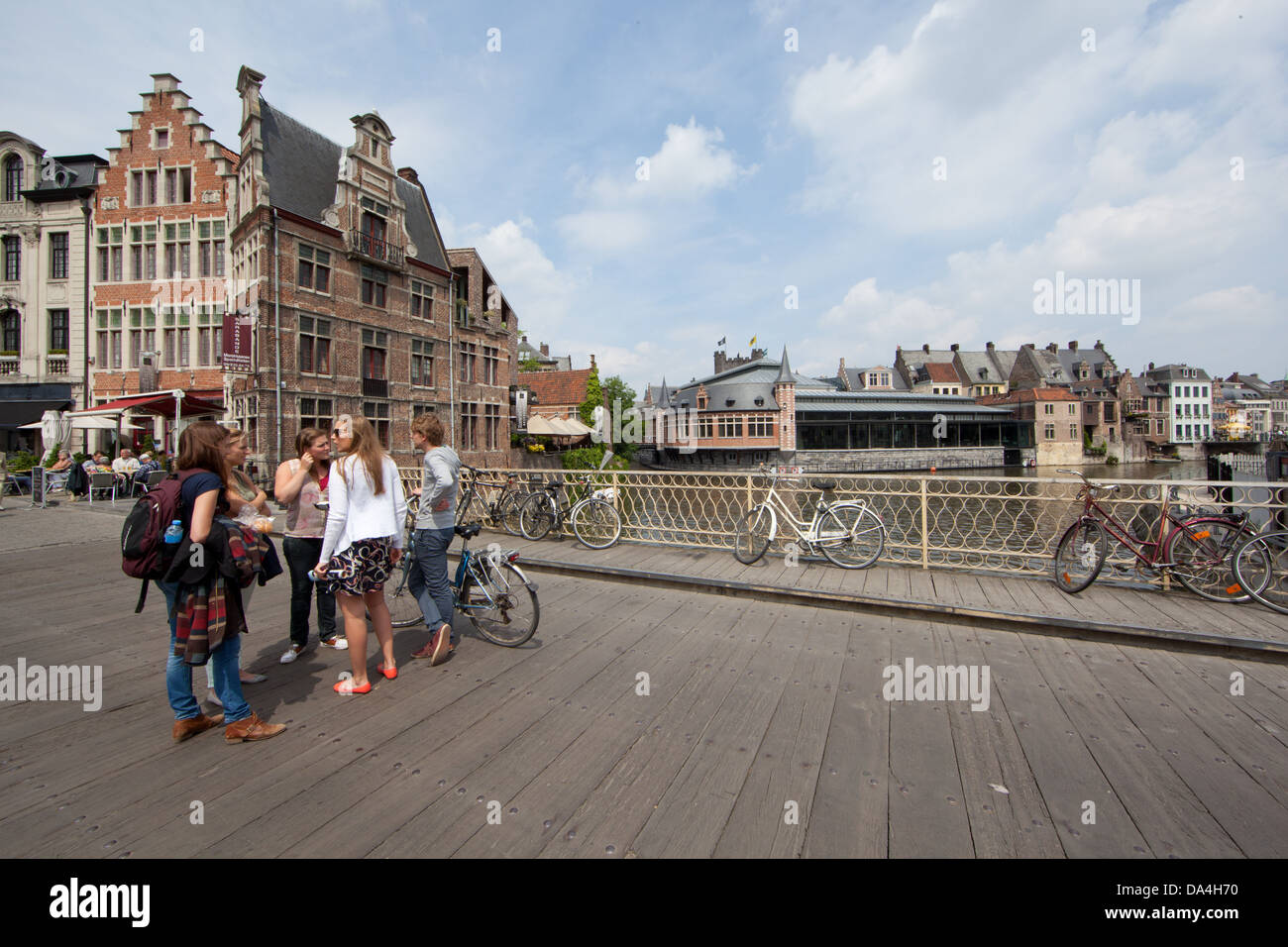 A small group of young people are chatting on one of the many canal ...