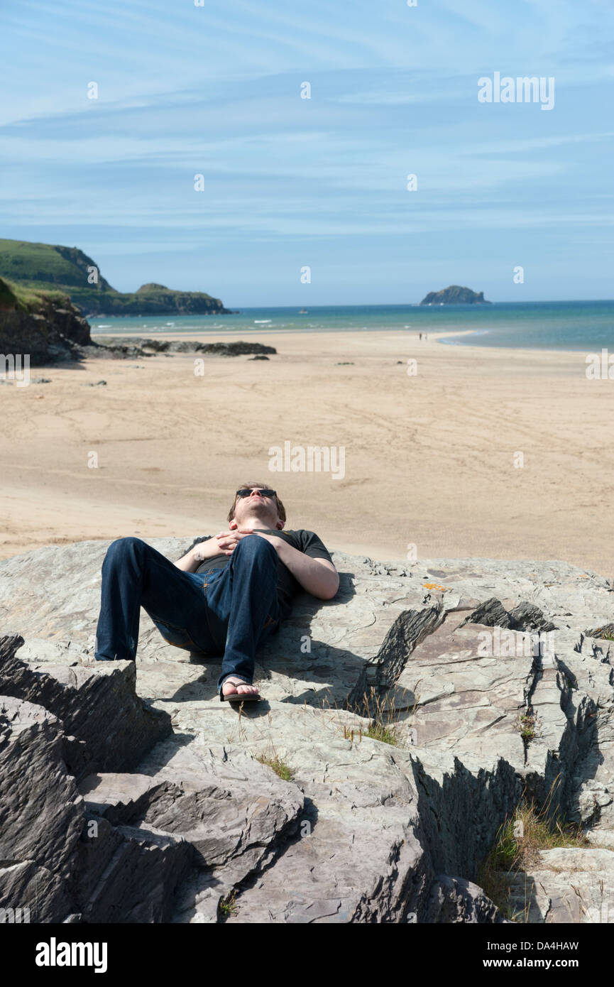 Man sunbathing on a beach hi-res stock photography and images - Alamy