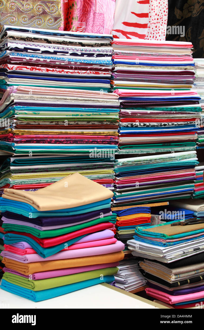 Fabric store with stacks of colorful textiles Stock Photo - Alamy