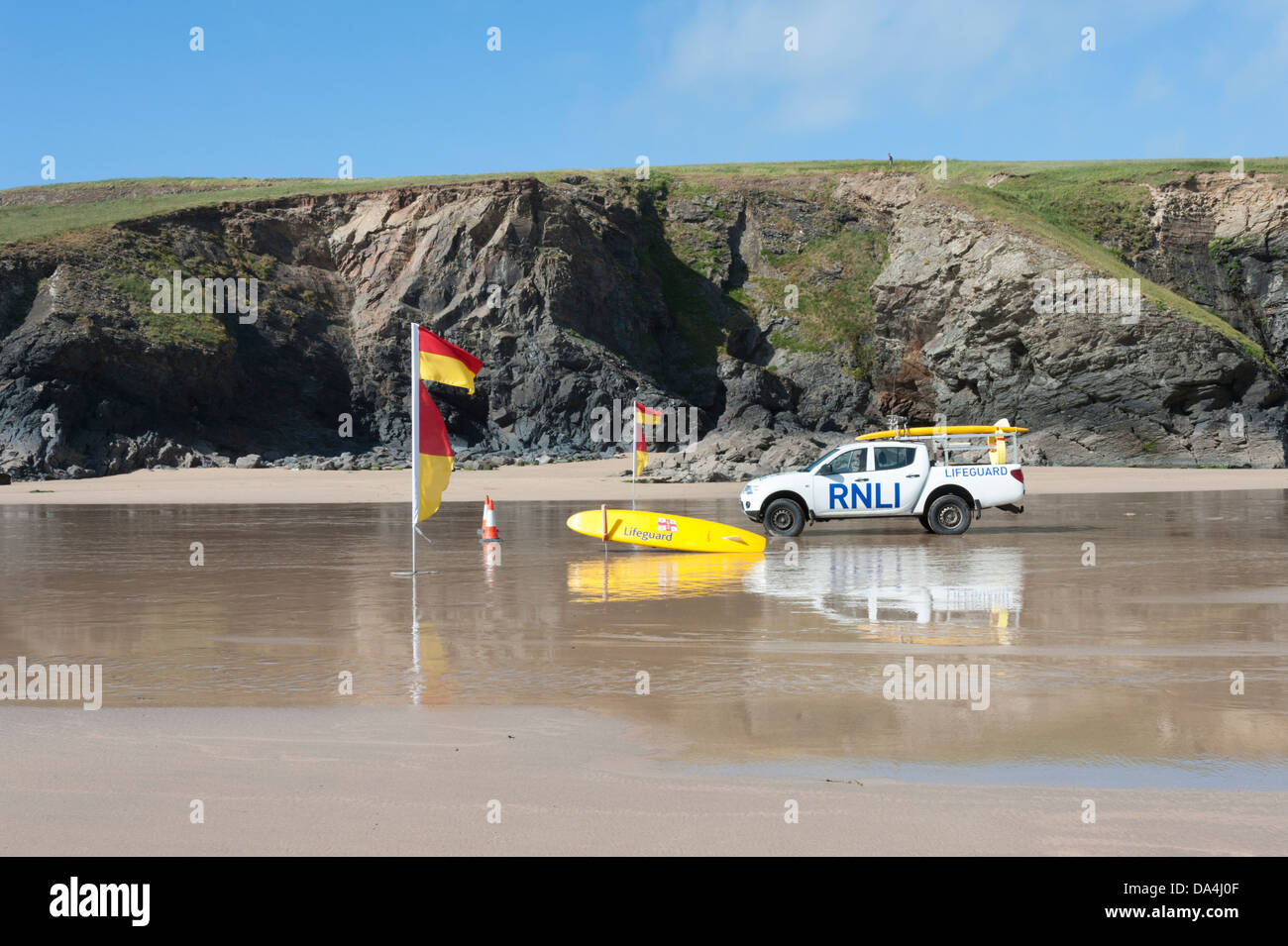 The RNLI lifeguards and their vehicle on the beach at Porthcothan Bay ...