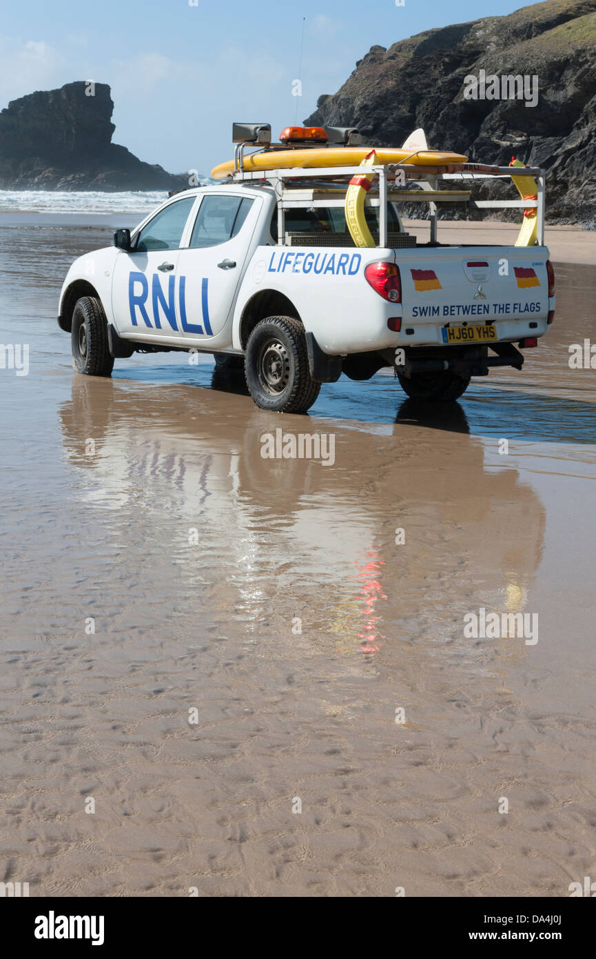 The RNLI lifeguards and their vehicle on the beach at Porthcothan Bay ...