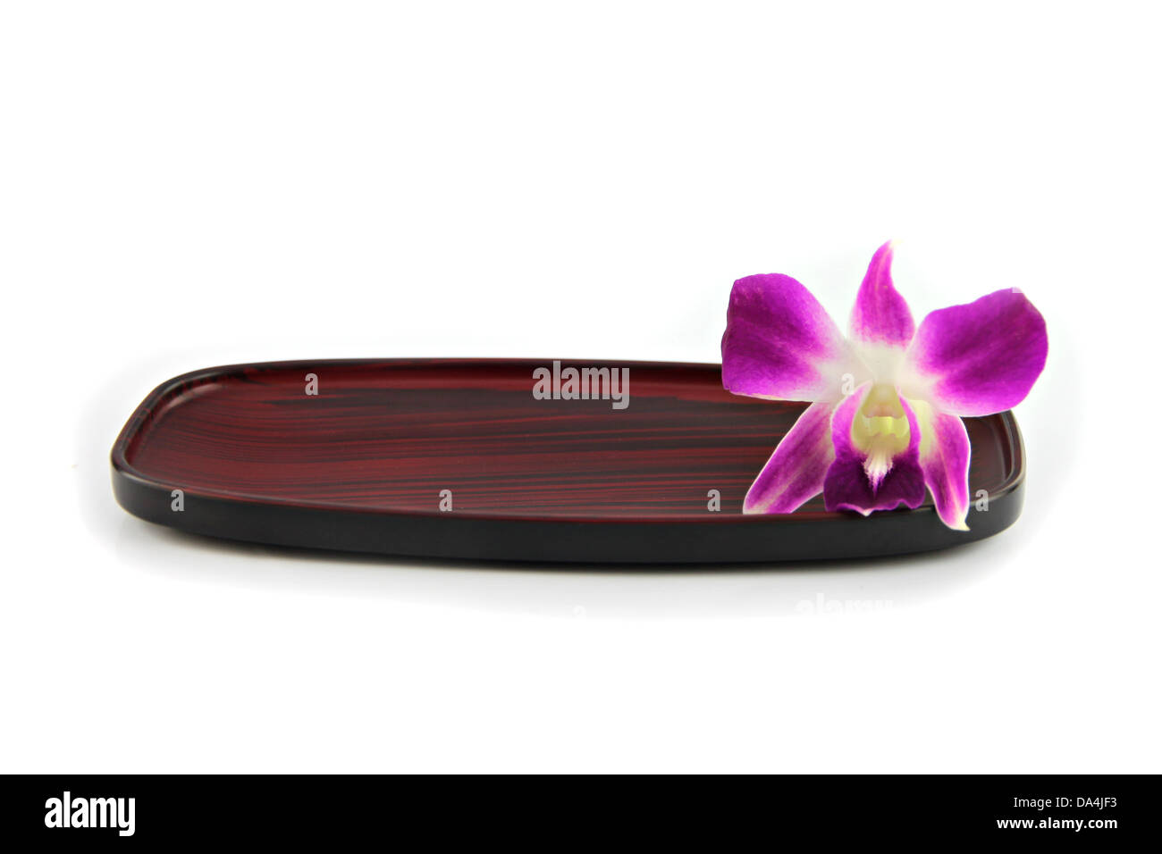 The Purple orchid on a wooden plate Stock Photo - Alamy