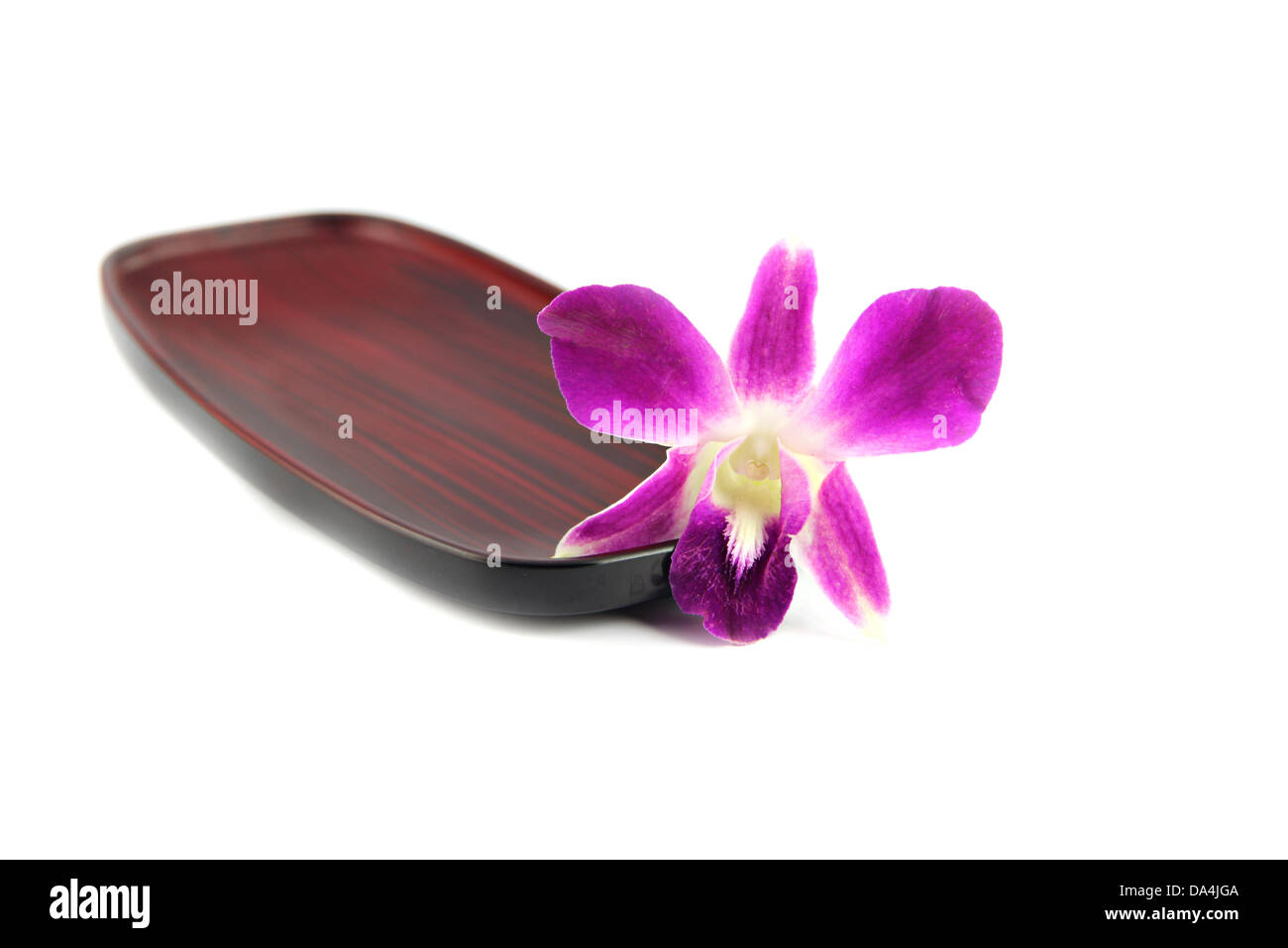 The Purple orchid on a wooden plate Stock Photo - Alamy