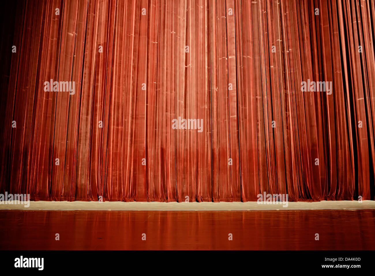 Pleated, red, hanging fabric stage curtain Stock Photo - Alamy