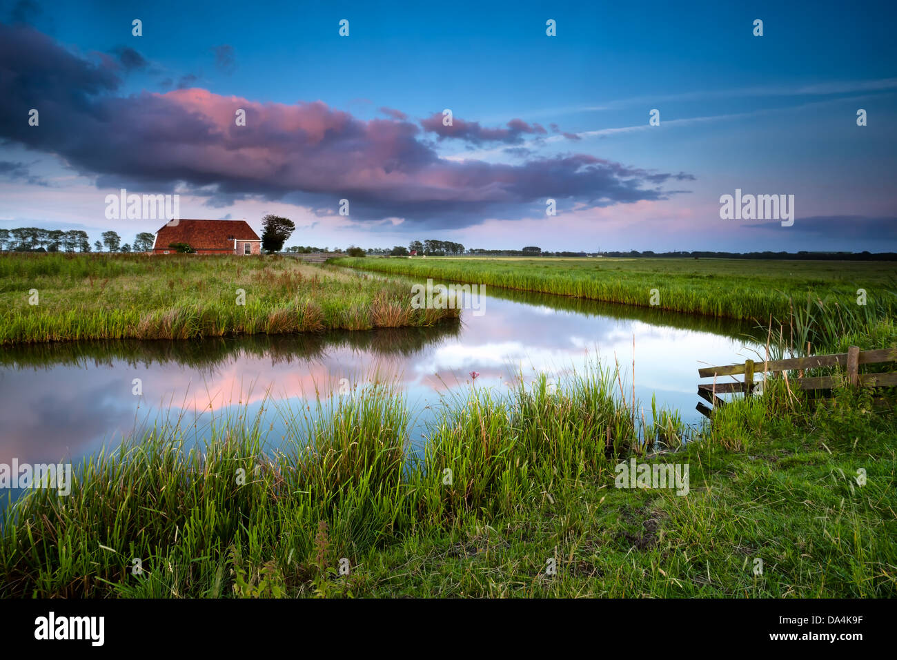 little farmhouse and river at colorful sunset, Groningen, Netherlands ...