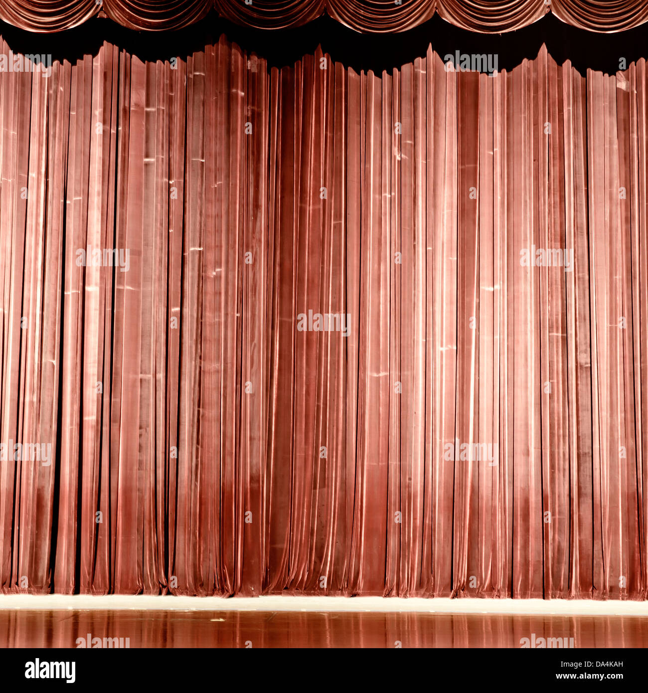 Pleated, red, hanging fabric stage curtain Stock Photo - Alamy