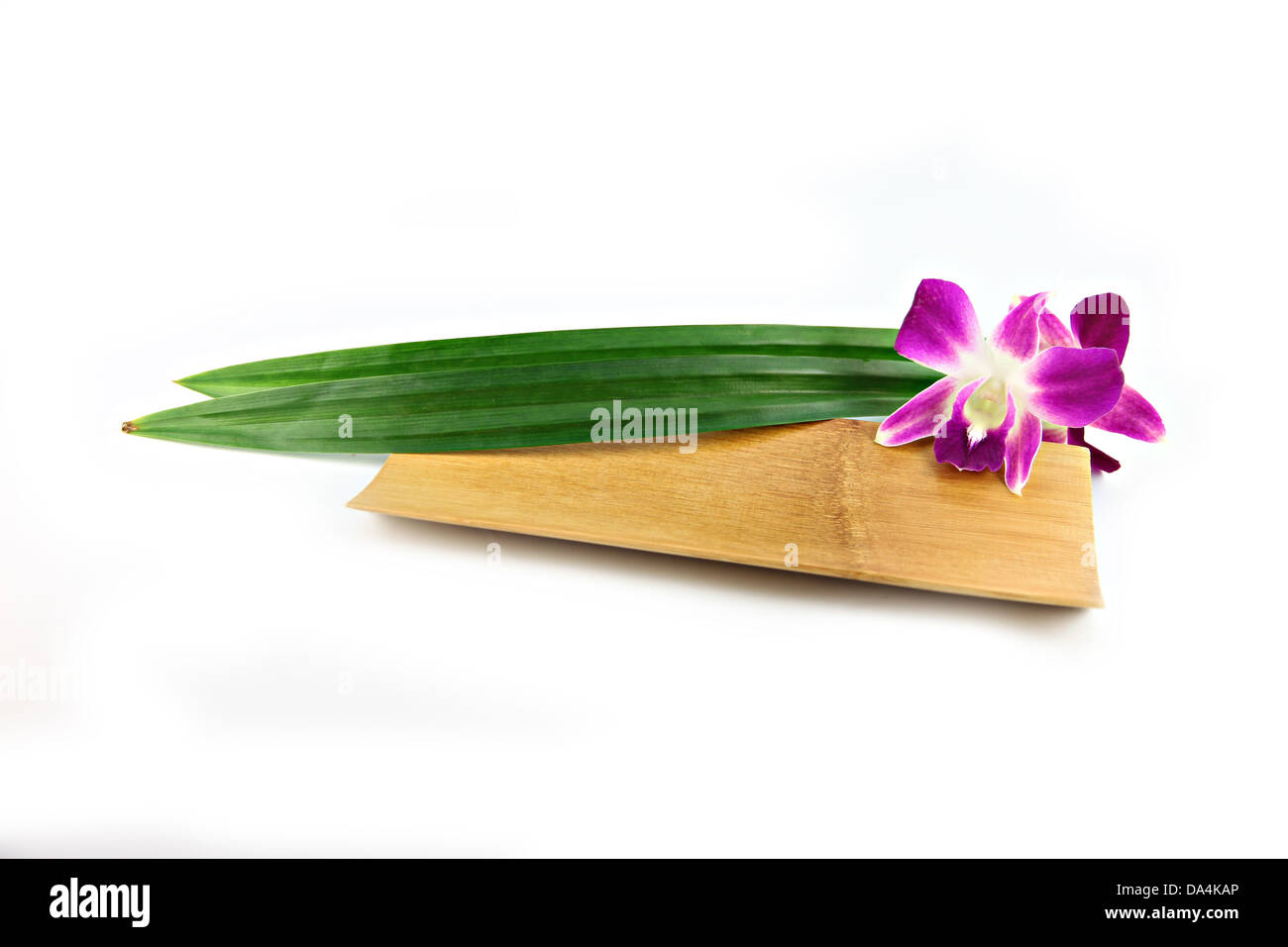 The Purple orchids and pandanus in bamboo dish on the white background ...