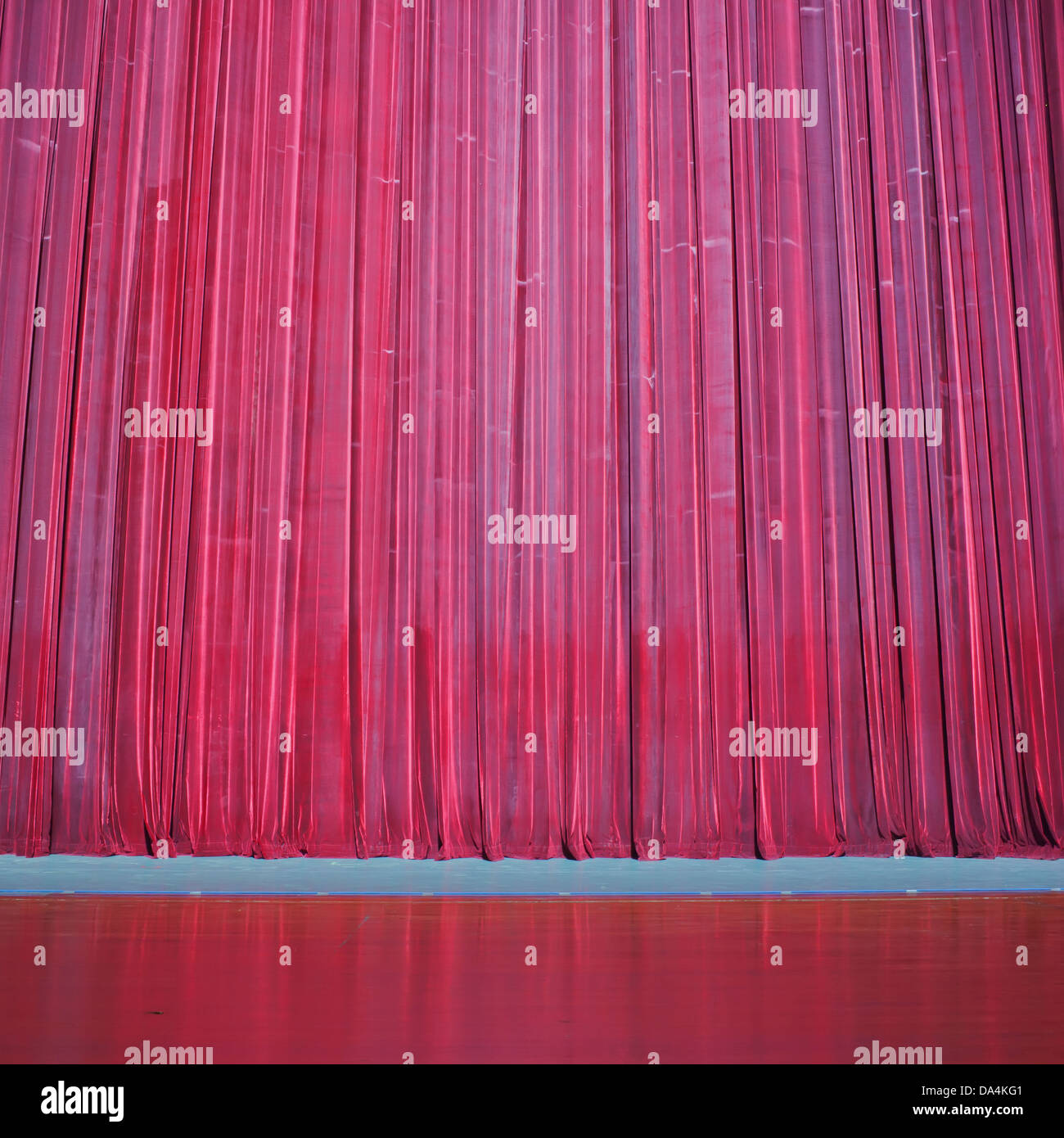 Pleated, red, hanging fabric stage curtain Stock Photo - Alamy