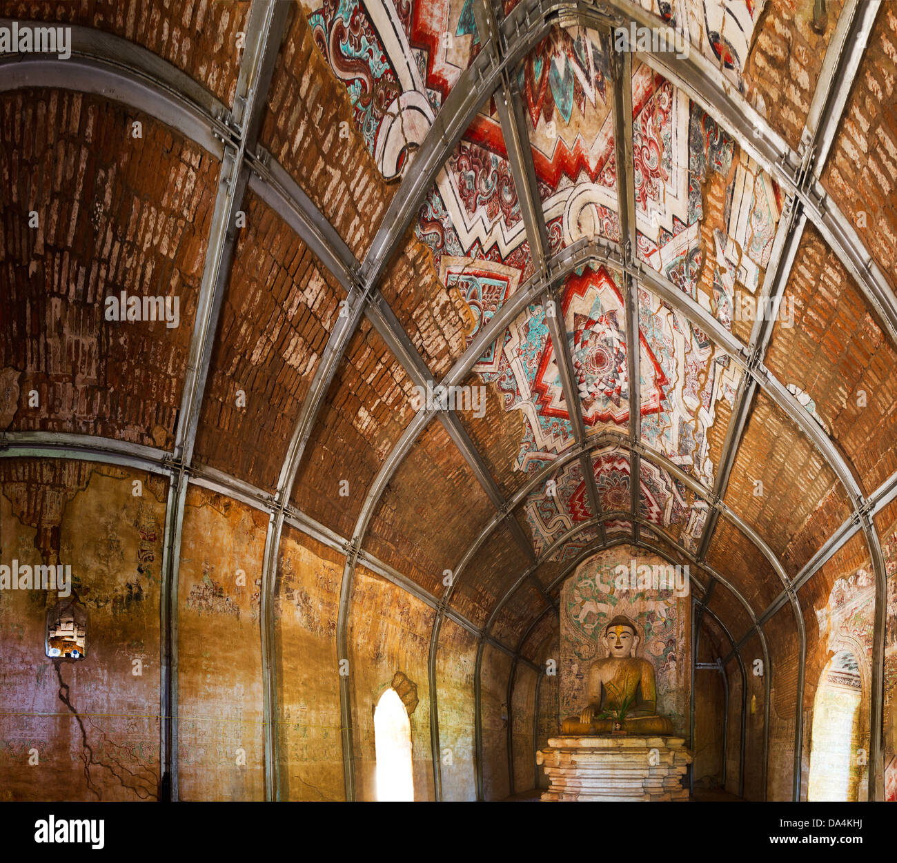 Bagan temple interior with old bricks, colorful painted walls and roof ...