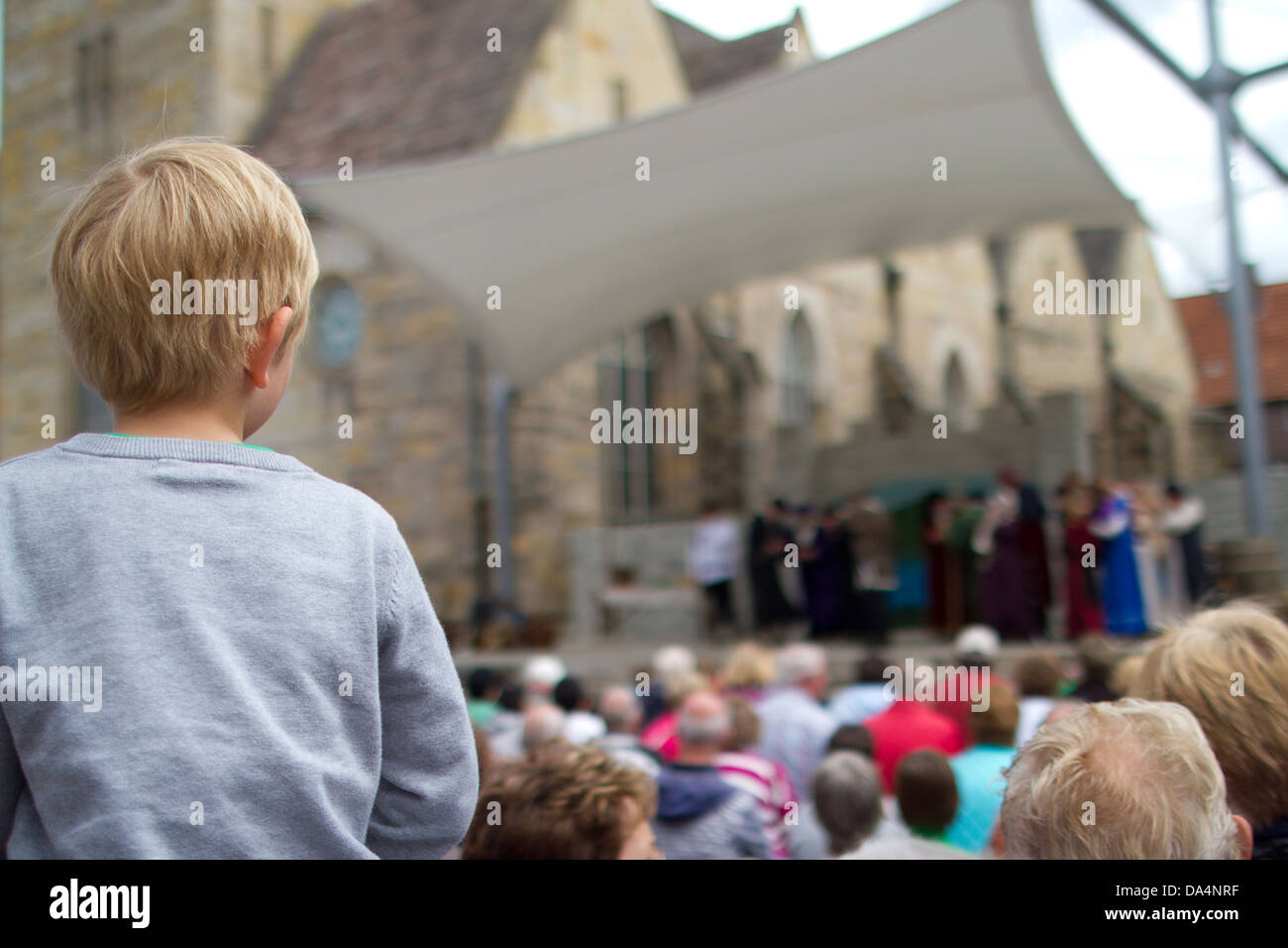 A young boy on his father's shoulders watches as the pied piper tale ...