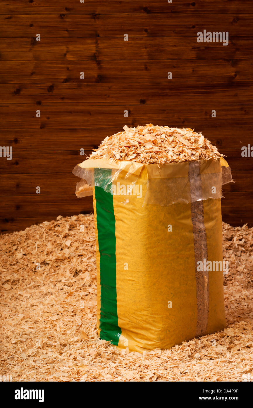 A new bale of wood shavings in horse stall for bedding Stock Photo - Alamy