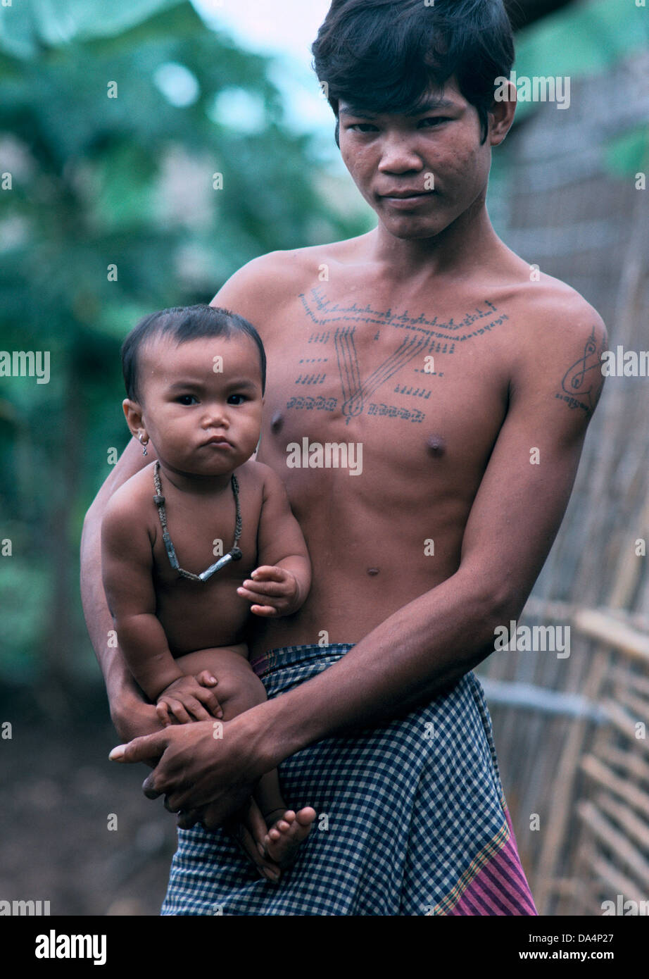 A Khmer Rouge solder at Site 8, holding his baby daughter He has ...