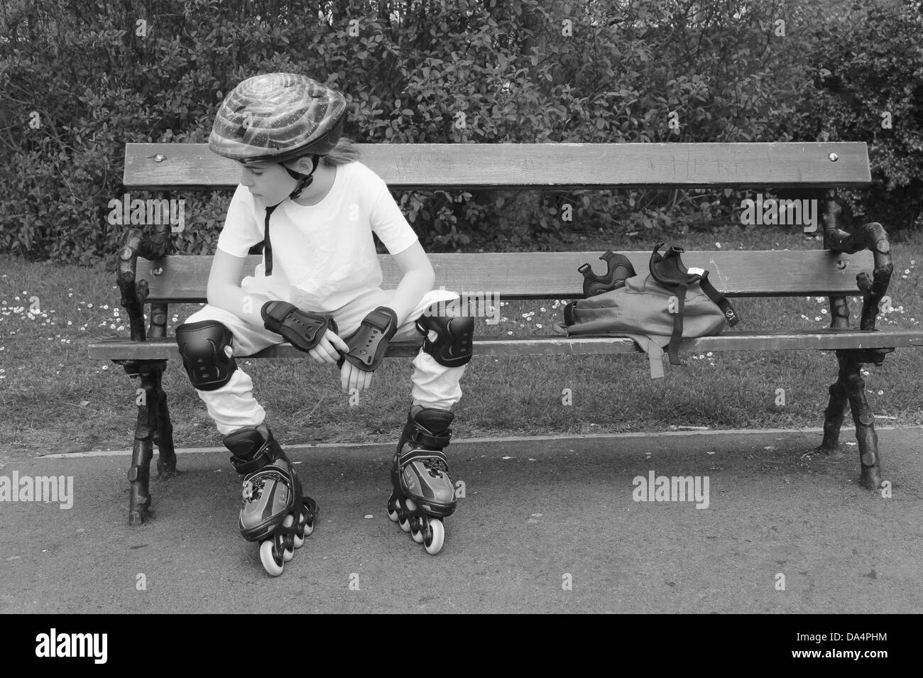 Rollerblading girl resting on a bench Stock Photo - Alamy