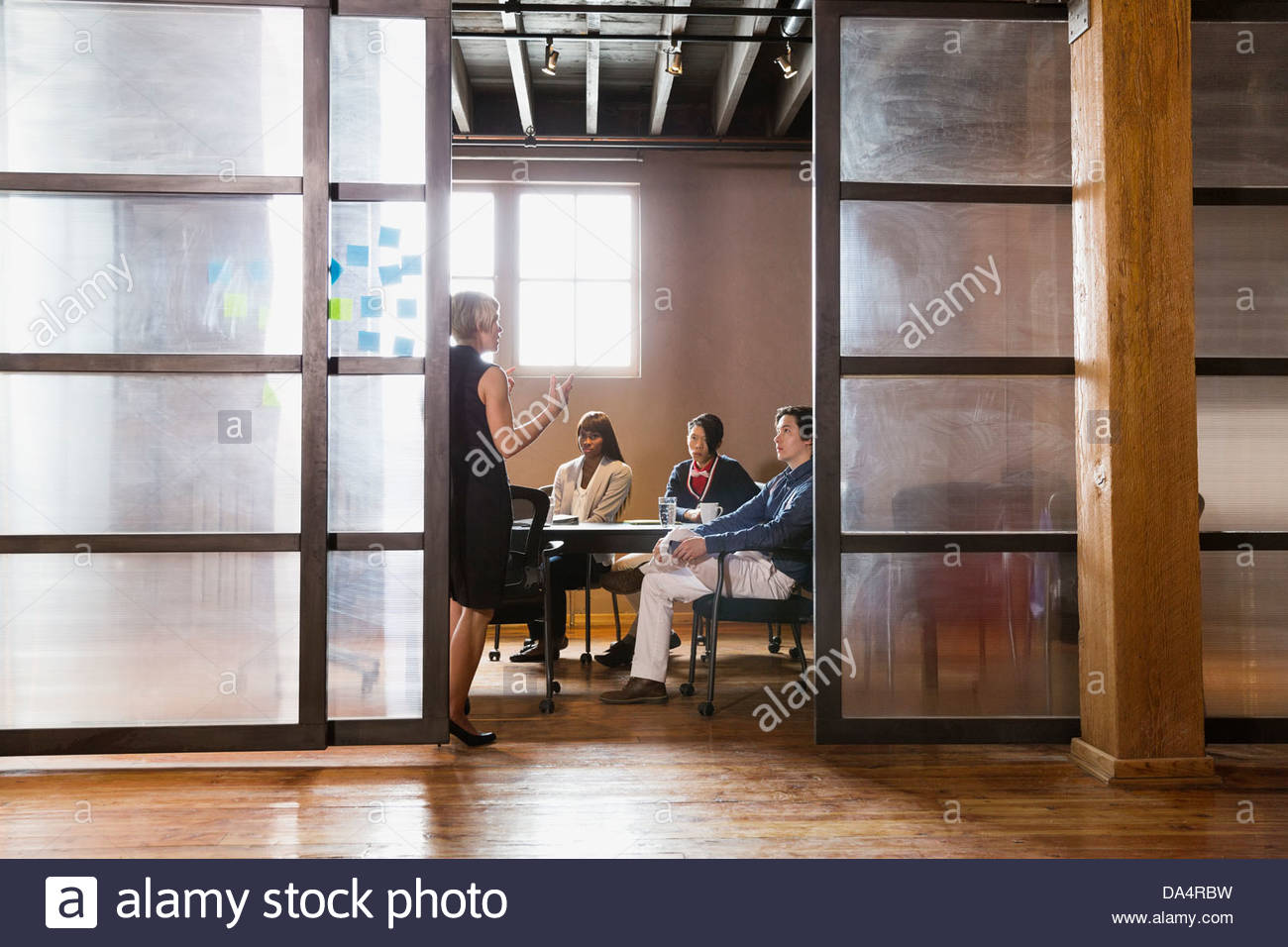 Group of entrepreneurs in meeting in creative office space Stock Photo ...