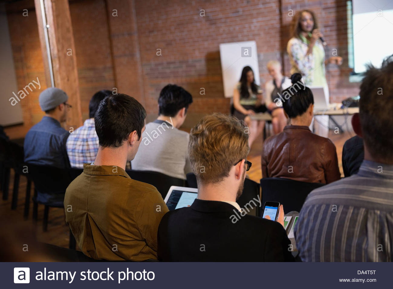 Entrepreneurs attending presentation in conference room Stock Photo - Alamy