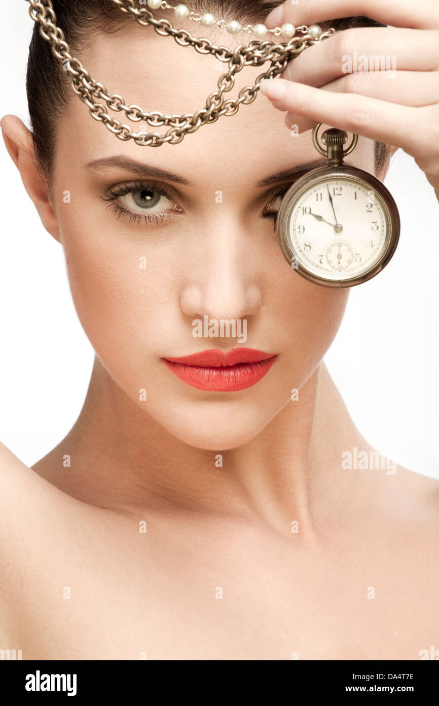 Beautiful model holding a vintage pocket watch in-front her face in ...