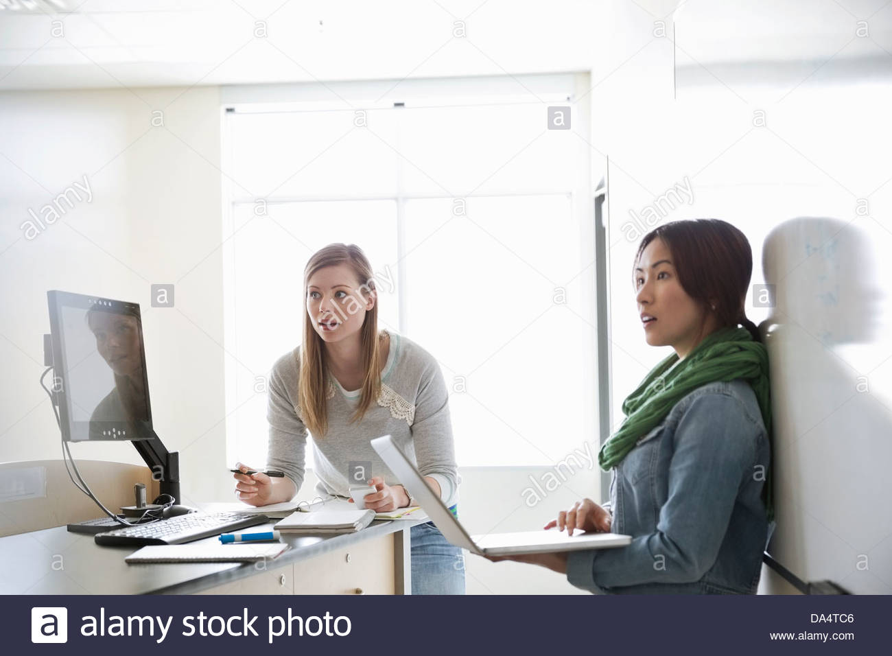 Female students working in classroom at college campus Stock Photo - Alamy