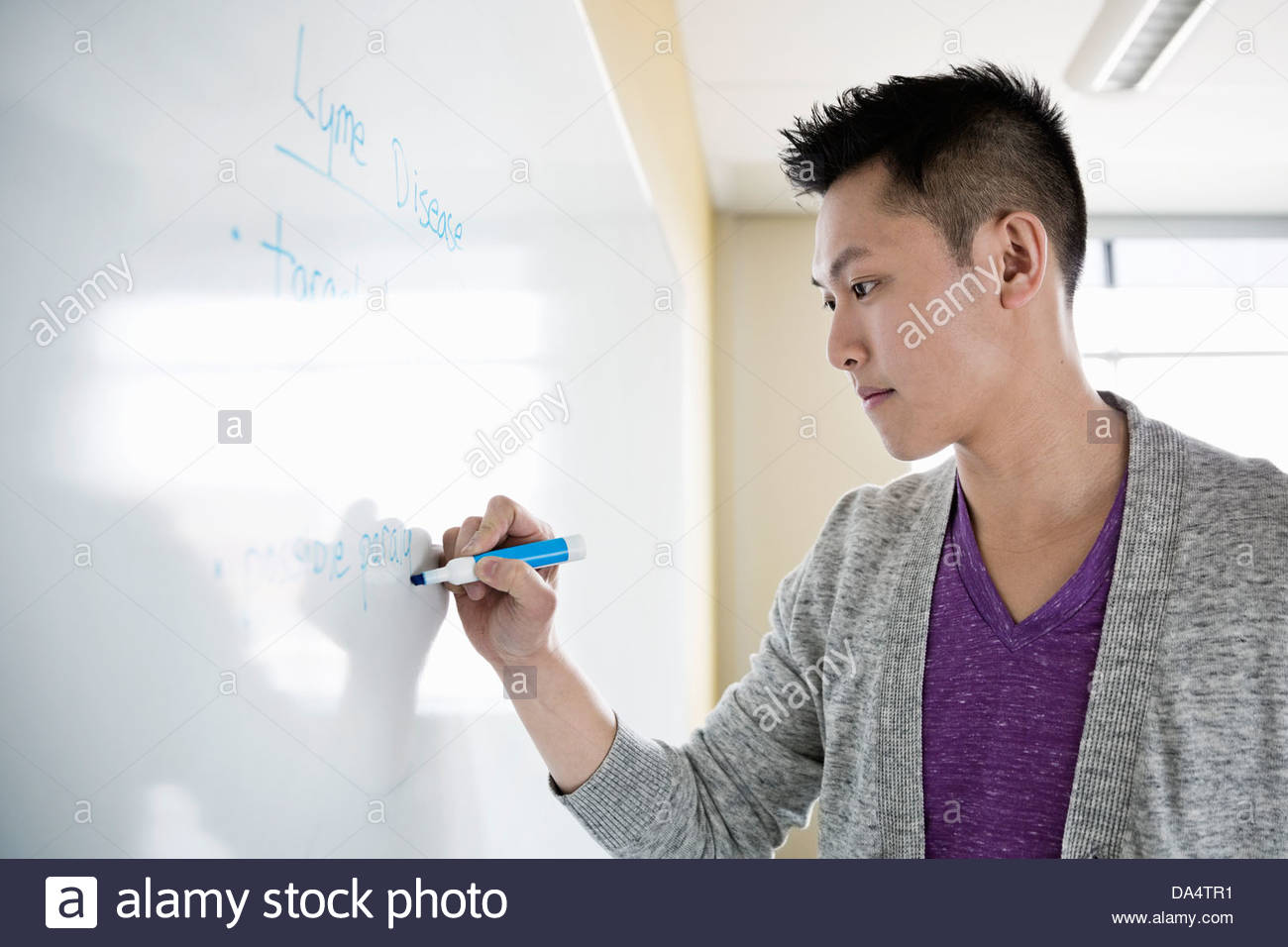 Asian male student writing hi-res stock photography and images - Alamy