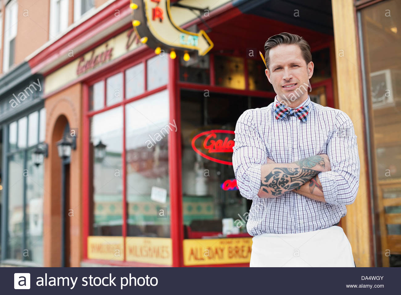 Portrait of male business owner standing outside diner Stock Photo - Alamy