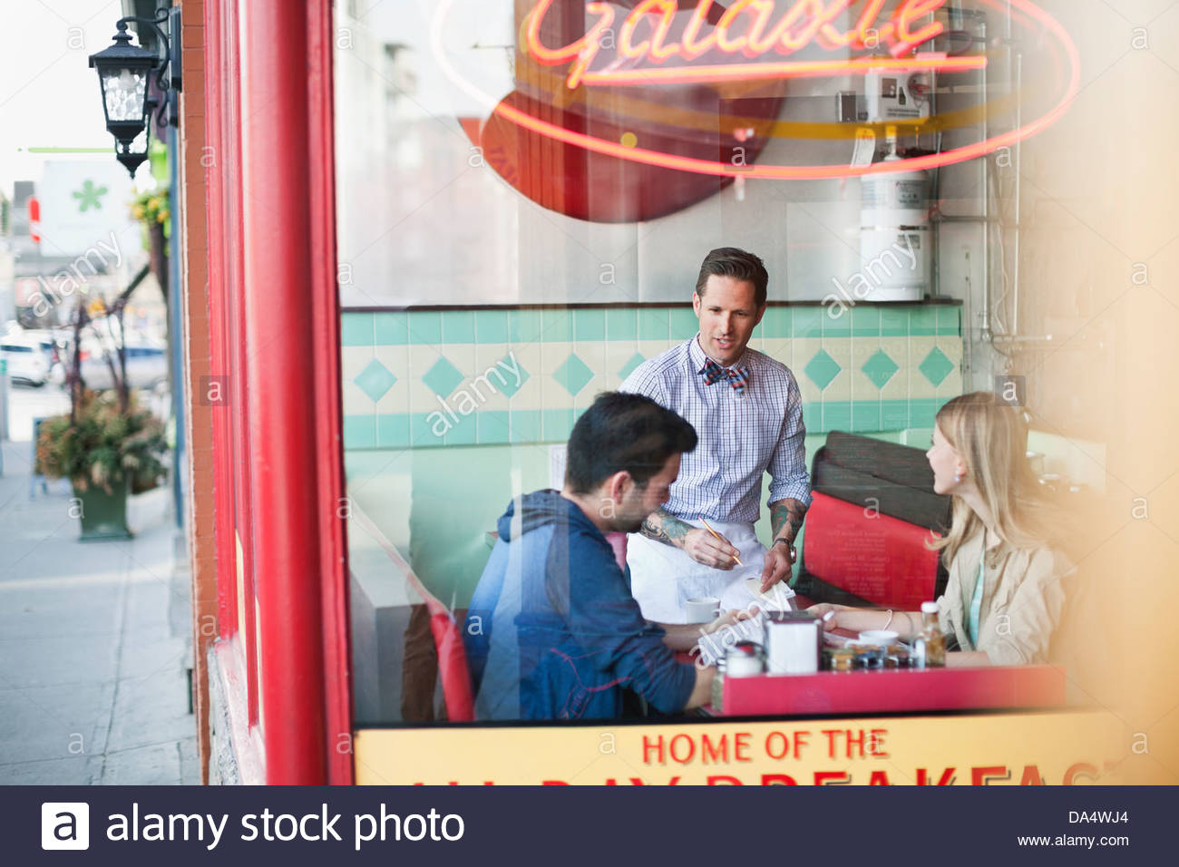 Waiter With Couple At Restaurant Stock Photos & Waiter With Couple At ...