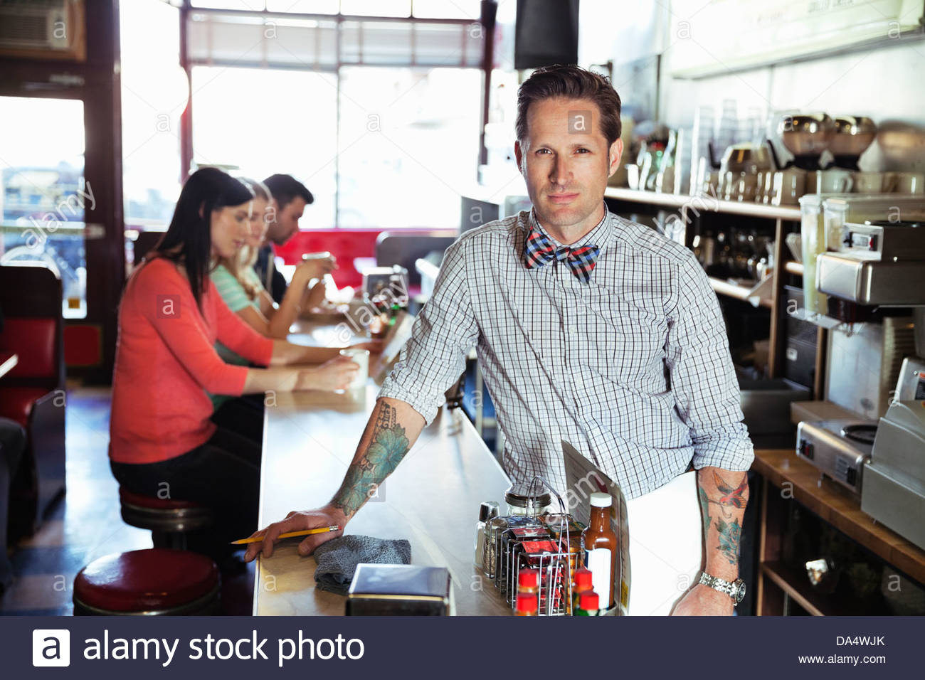 Portrait of male diner owner at counter Stock Photo - Alamy