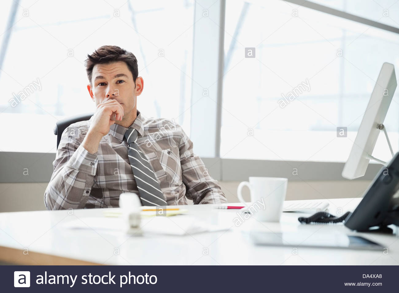 Businessman sitting at desk hi-res stock photography and images - Alamy