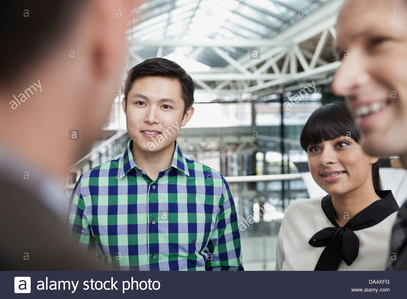 Business people talking together in office building Stock Photo - Alamy