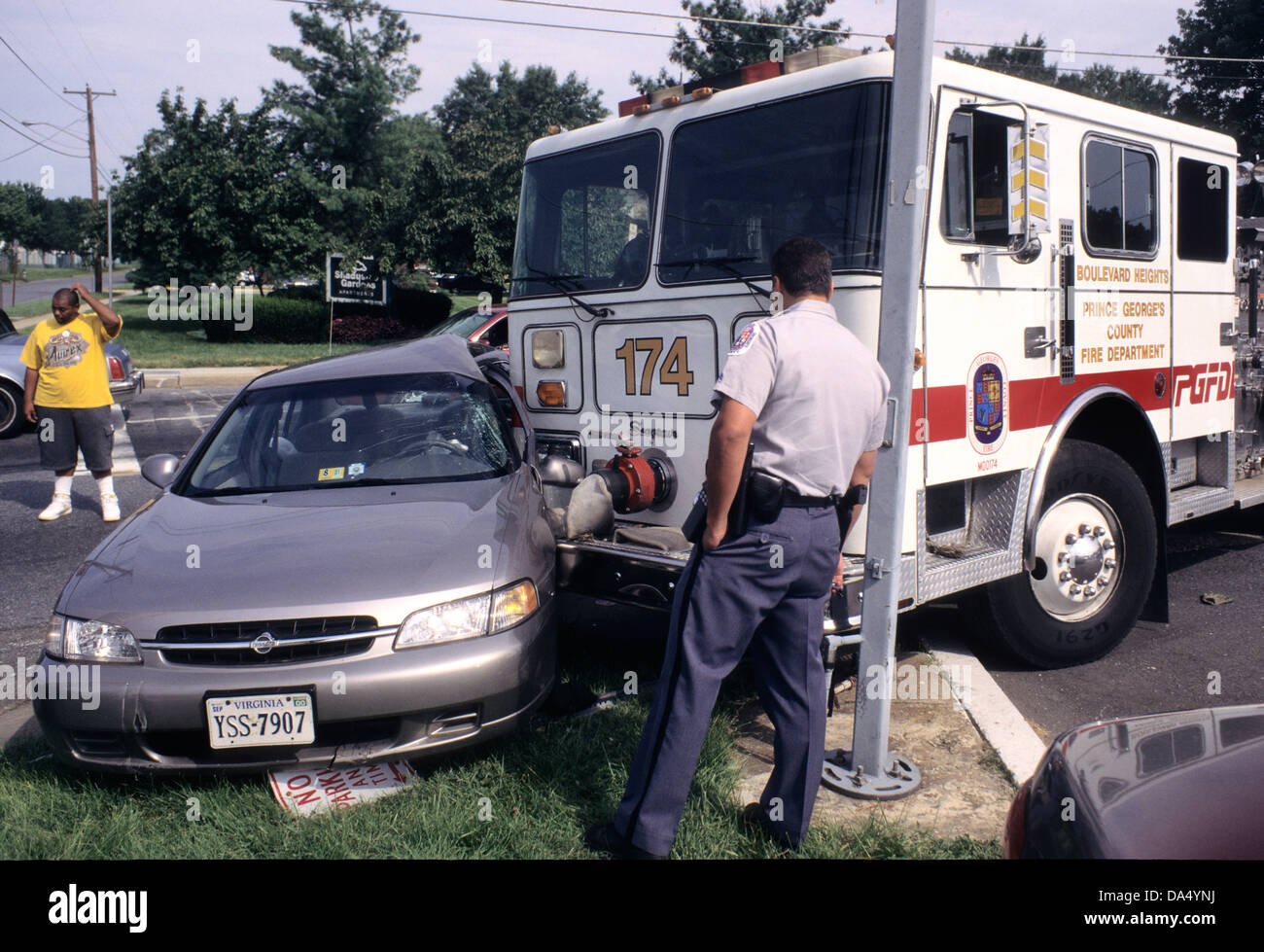 Policeman examines an accident scene where a fire truck hit a car in ...
