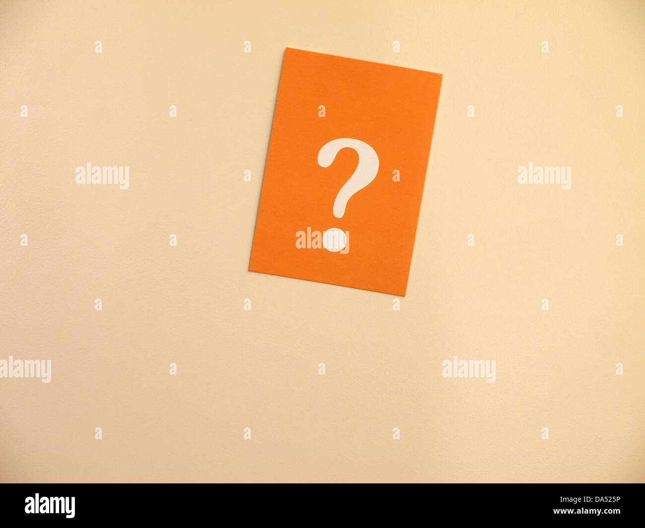 Orange card with a question mark on a bright background Stock Photo - Alamy