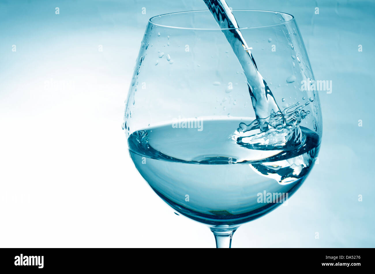 Pouring fresh water in blue Stock Photo - Alamy