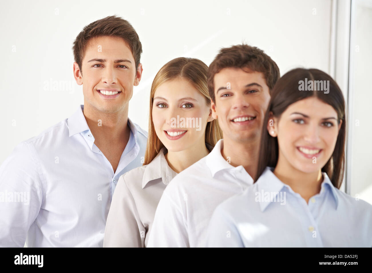 Young business team standing behind each other in a row Stock Photo - Alamy